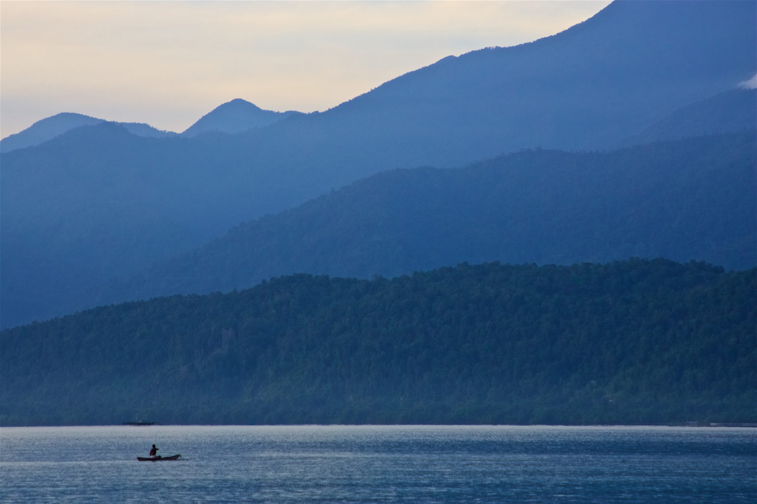 View of Arfak Mountains across bay from outside town of Manokwari. ©Tim ...